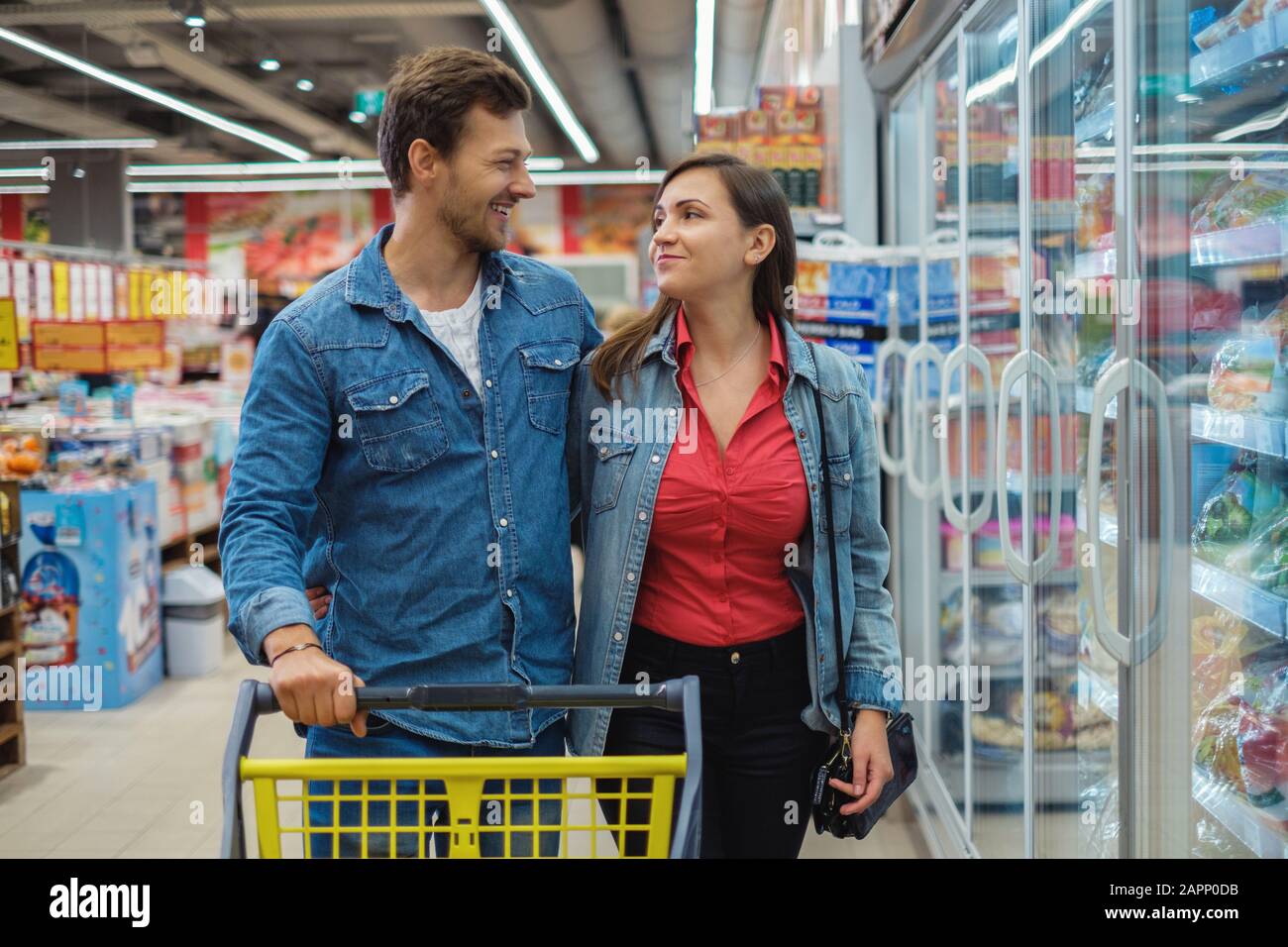 Couple choosing goods in a grocery store Stock Photo - Alamy
