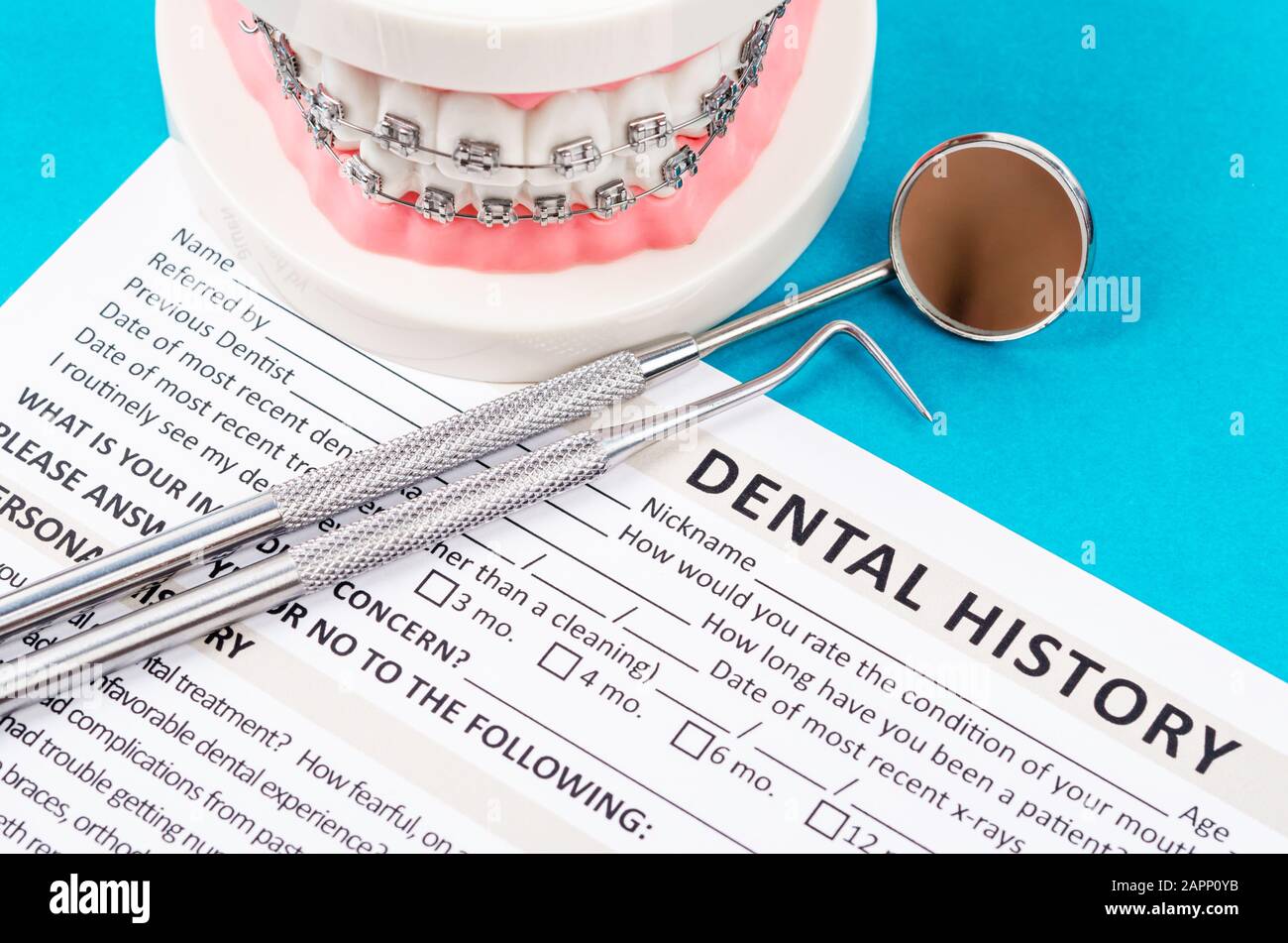 New patient medical form with model tooth and dental instruments ...