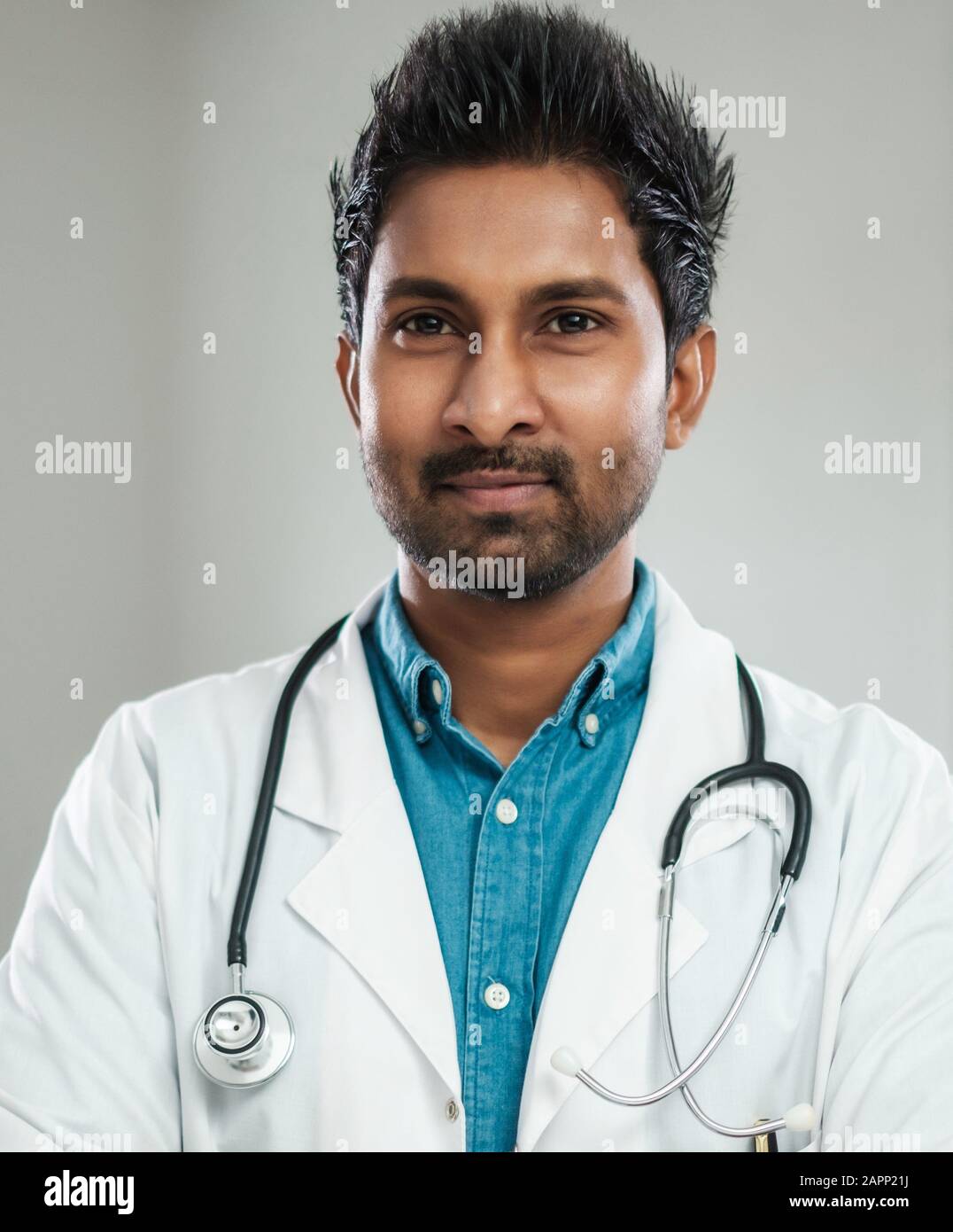 Indian doctor with stethoscope around neck in his office Stock Photo ...
