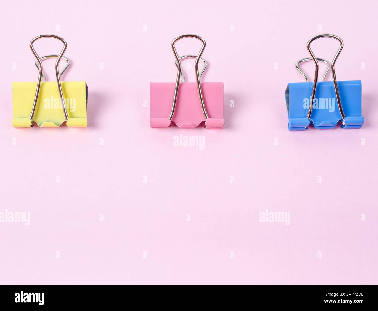 Colorful binder clips on pink paper background with empty space Stock ...