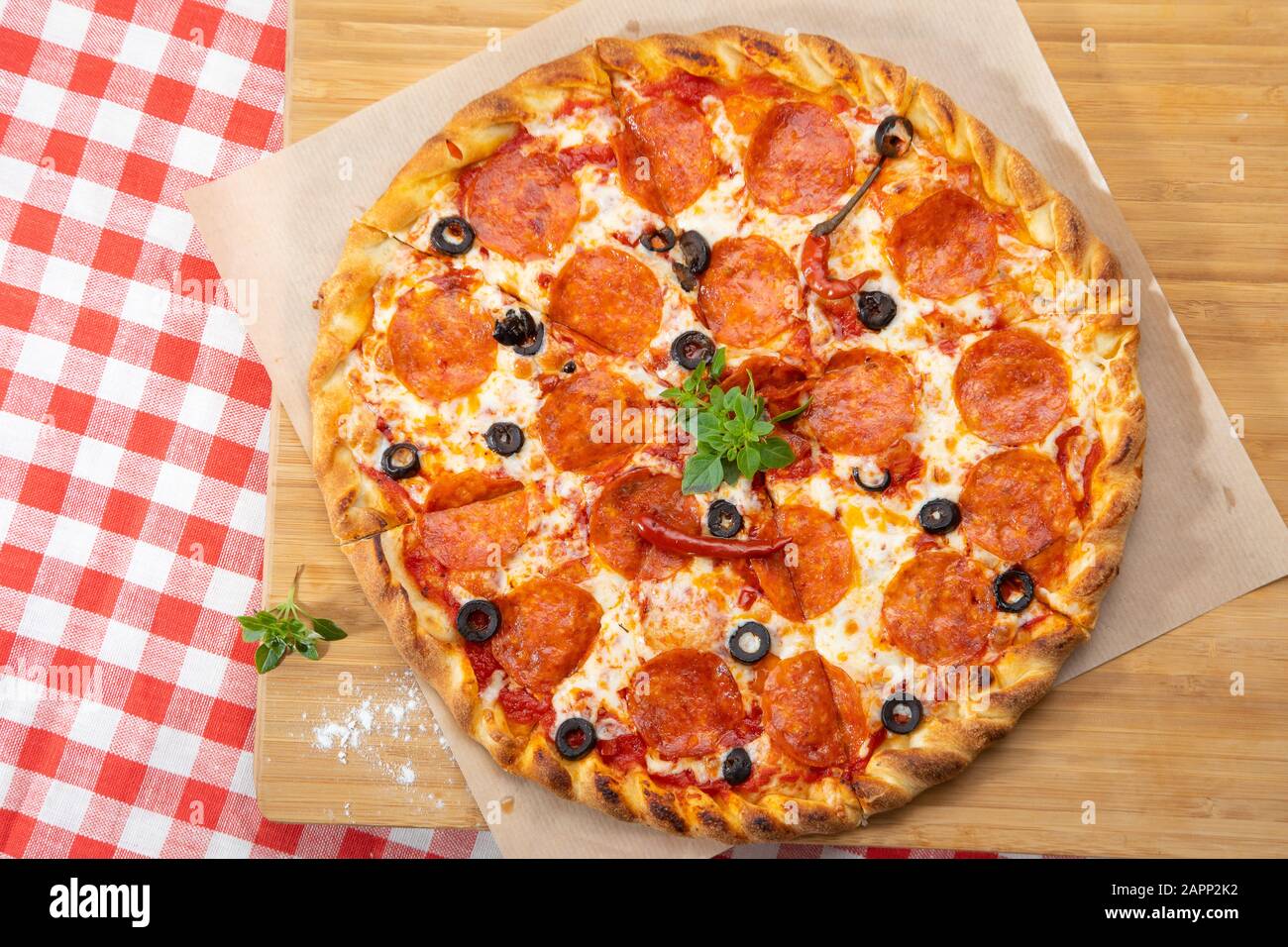 Pepperoni pizza close-up with various ingredients decorated with Basil ...
