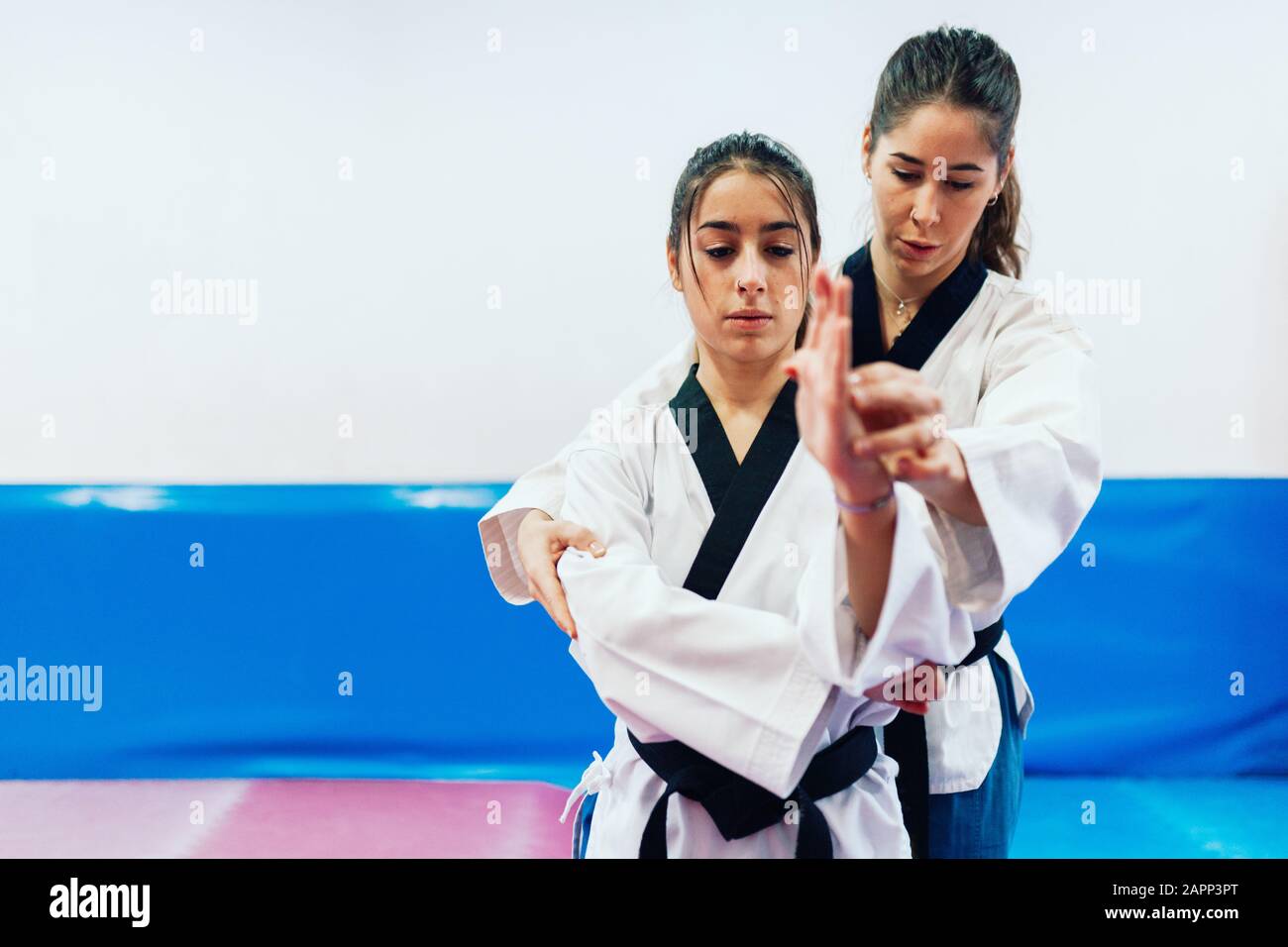 Two young women practice taekwondo in a training center Stock Photo - Alamy