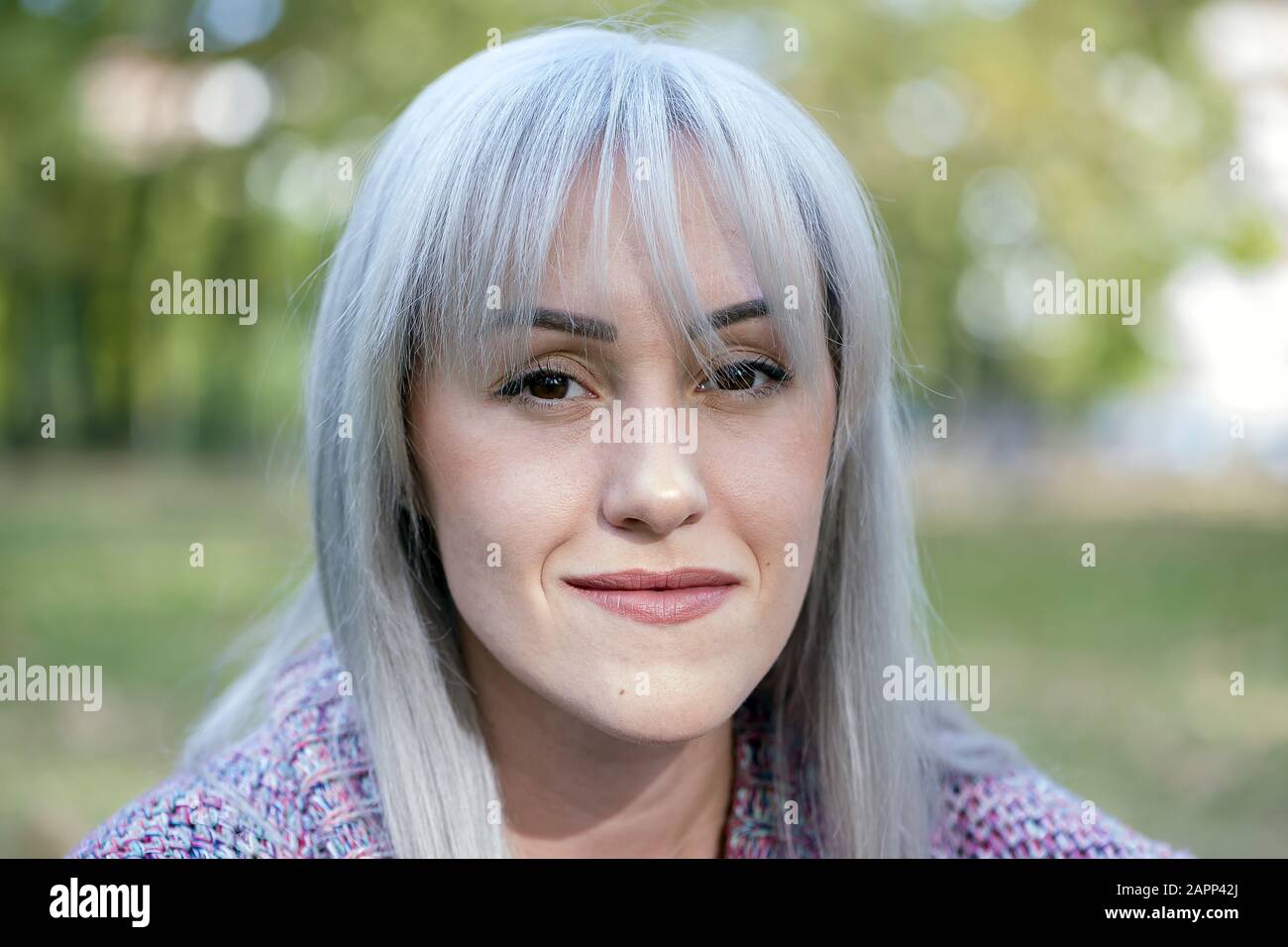 Outdoors portrait of a woman making funny faces. Silver hair Stock ...
