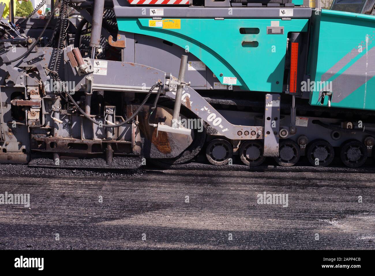 Road construction. Heavy asphalt laying machine during work Stock Photo ...