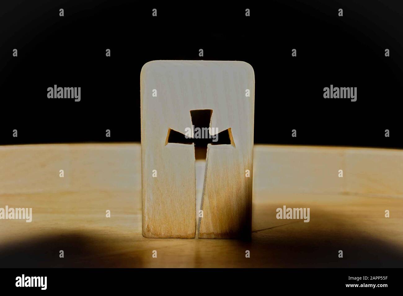 The hollow shape of a cross, the Christian symbol of faith, carved from ...