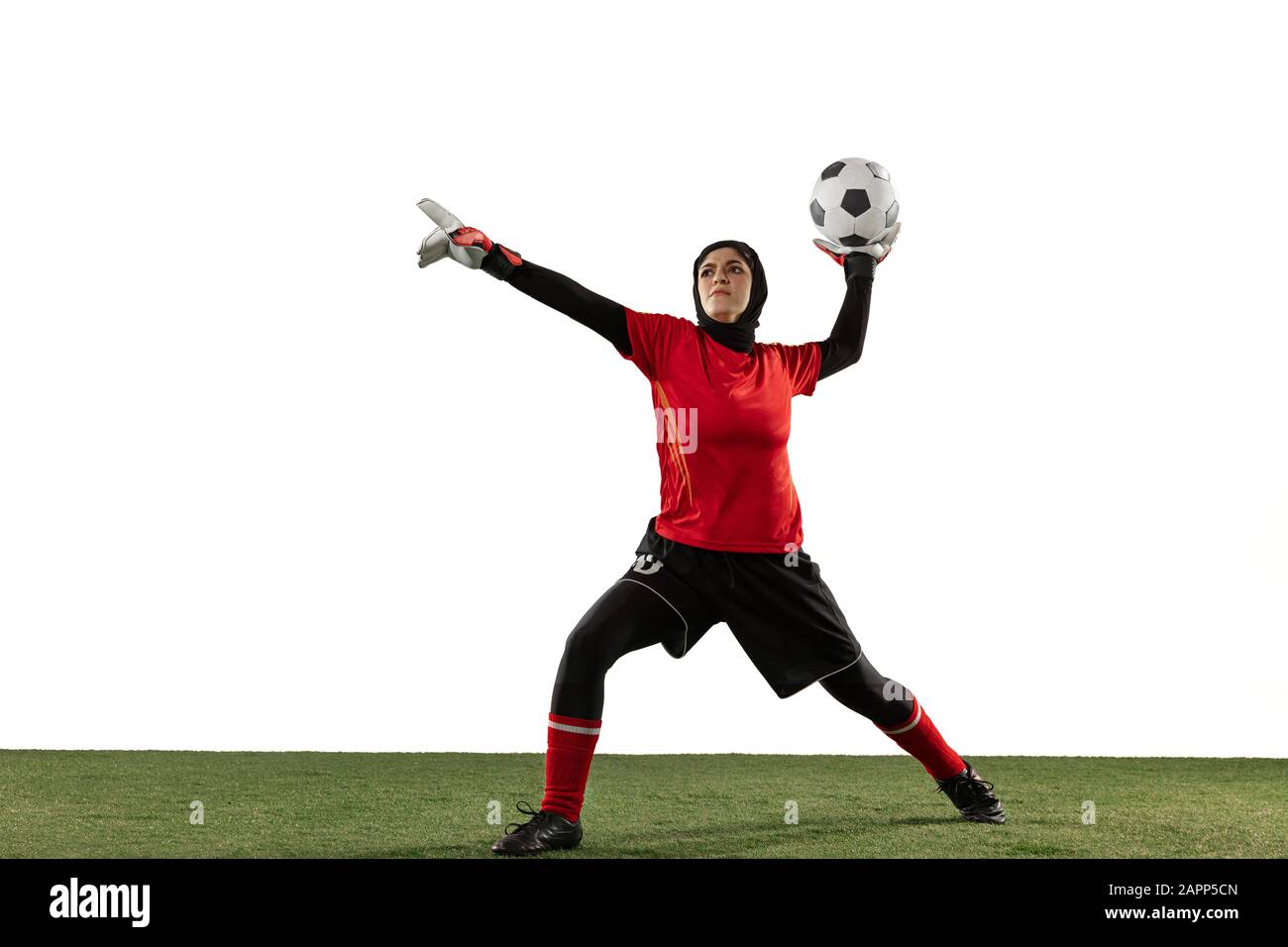 Arabian female soccer or football player, goalkeeper on white studio ...
