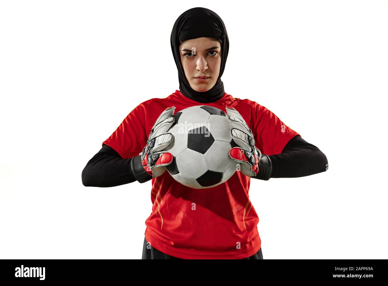 Arabian female soccer or football player, goalkeeper on white studio ...