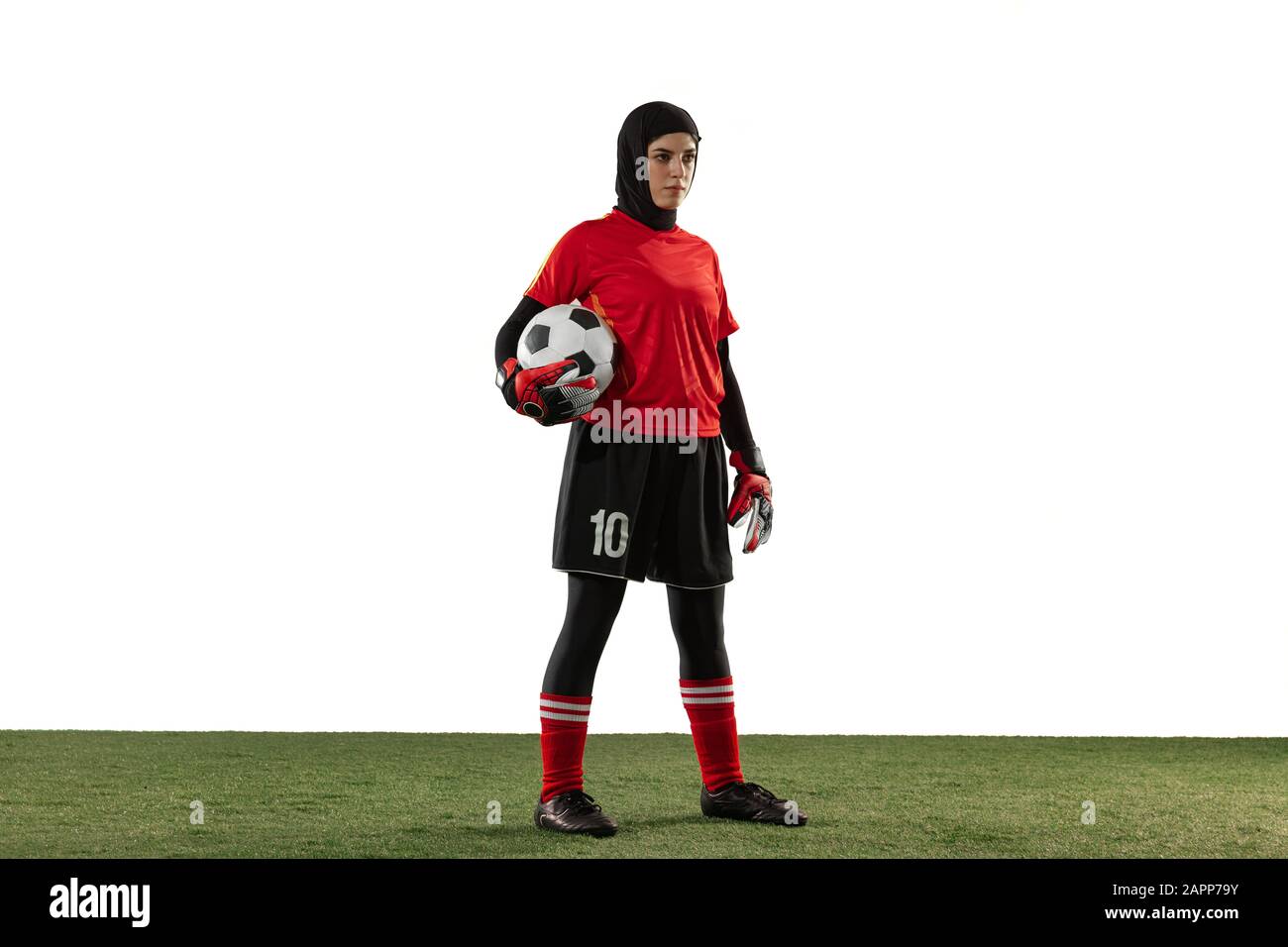 Arabian female soccer or football player, goalkeeper on white studio ...