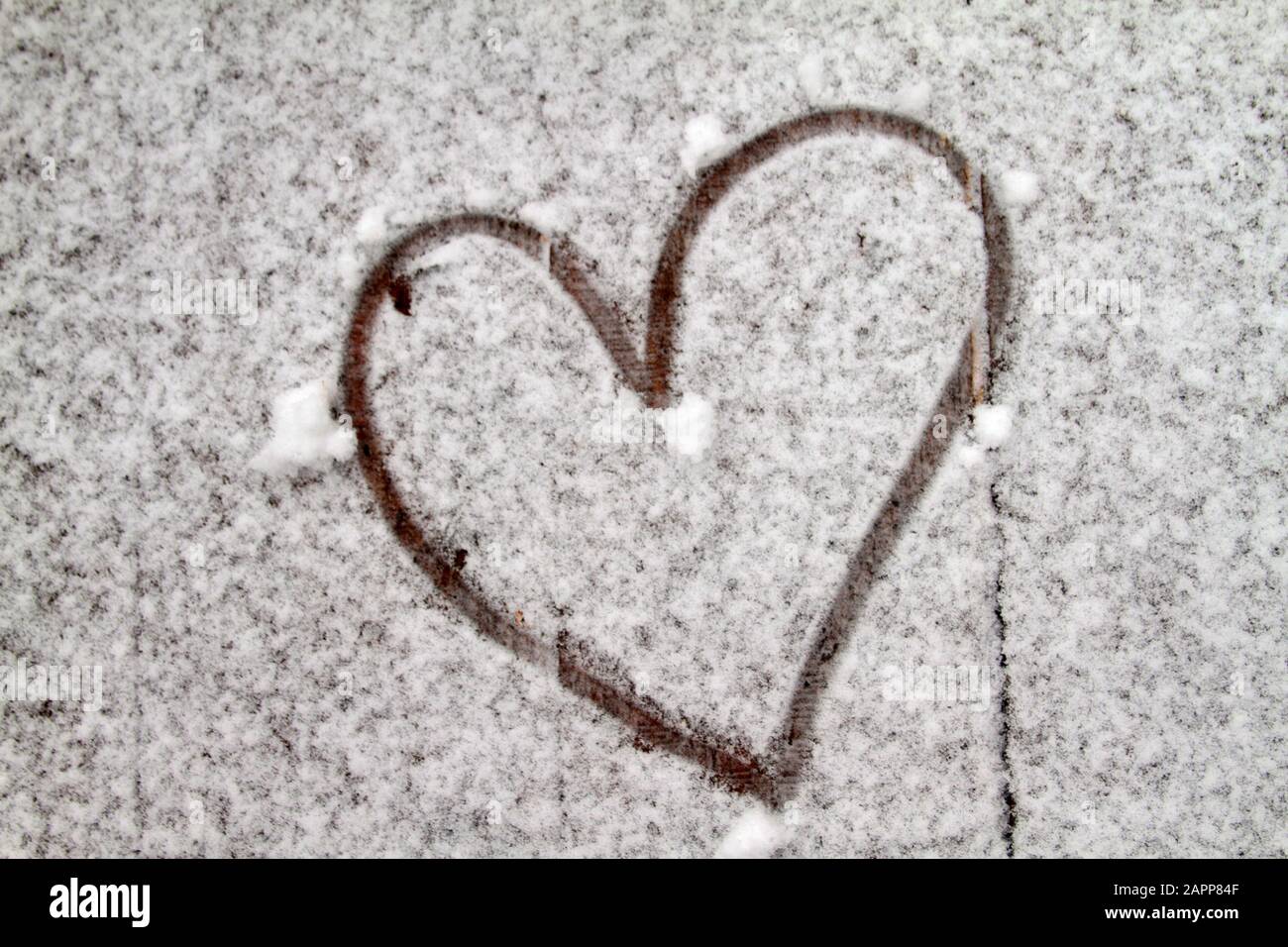 Heart shape drawn on snow-covered surface Stock Photo - Alamy