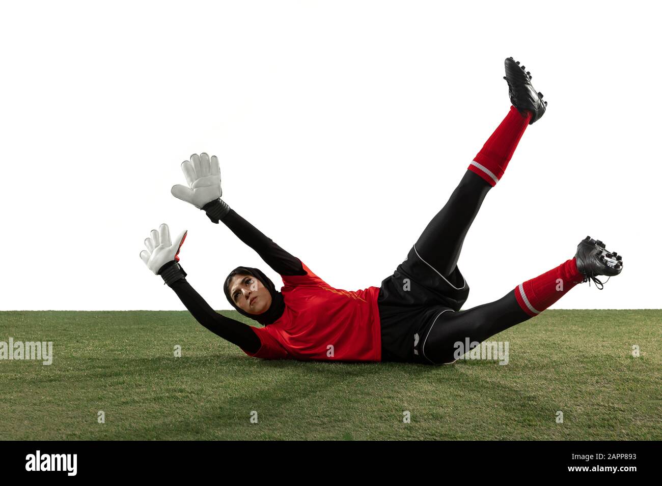 Arabian female soccer or football player, goalkeeper on white studio ...