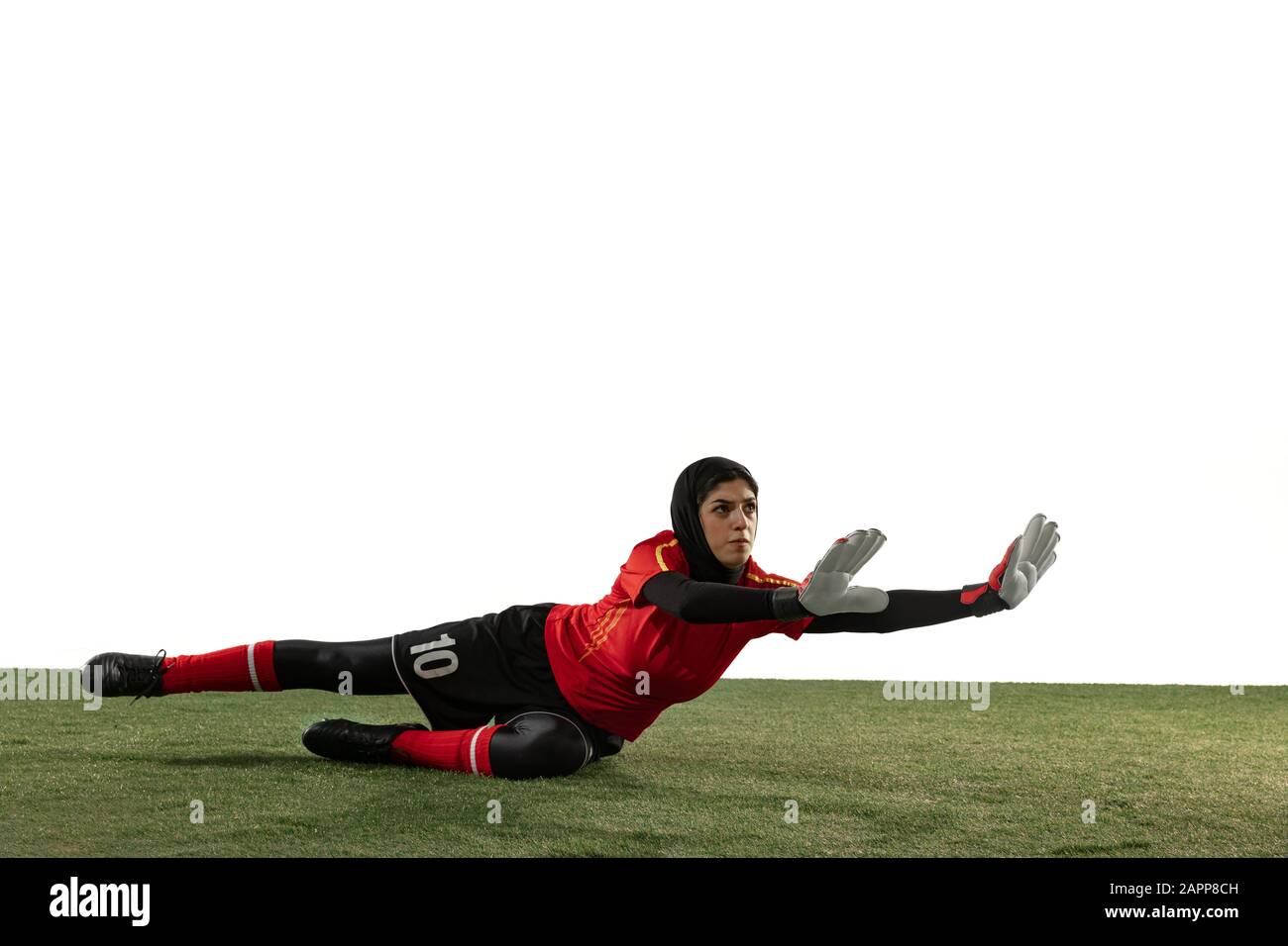 Arabian female soccer or football player, goalkeeper on white studio ...