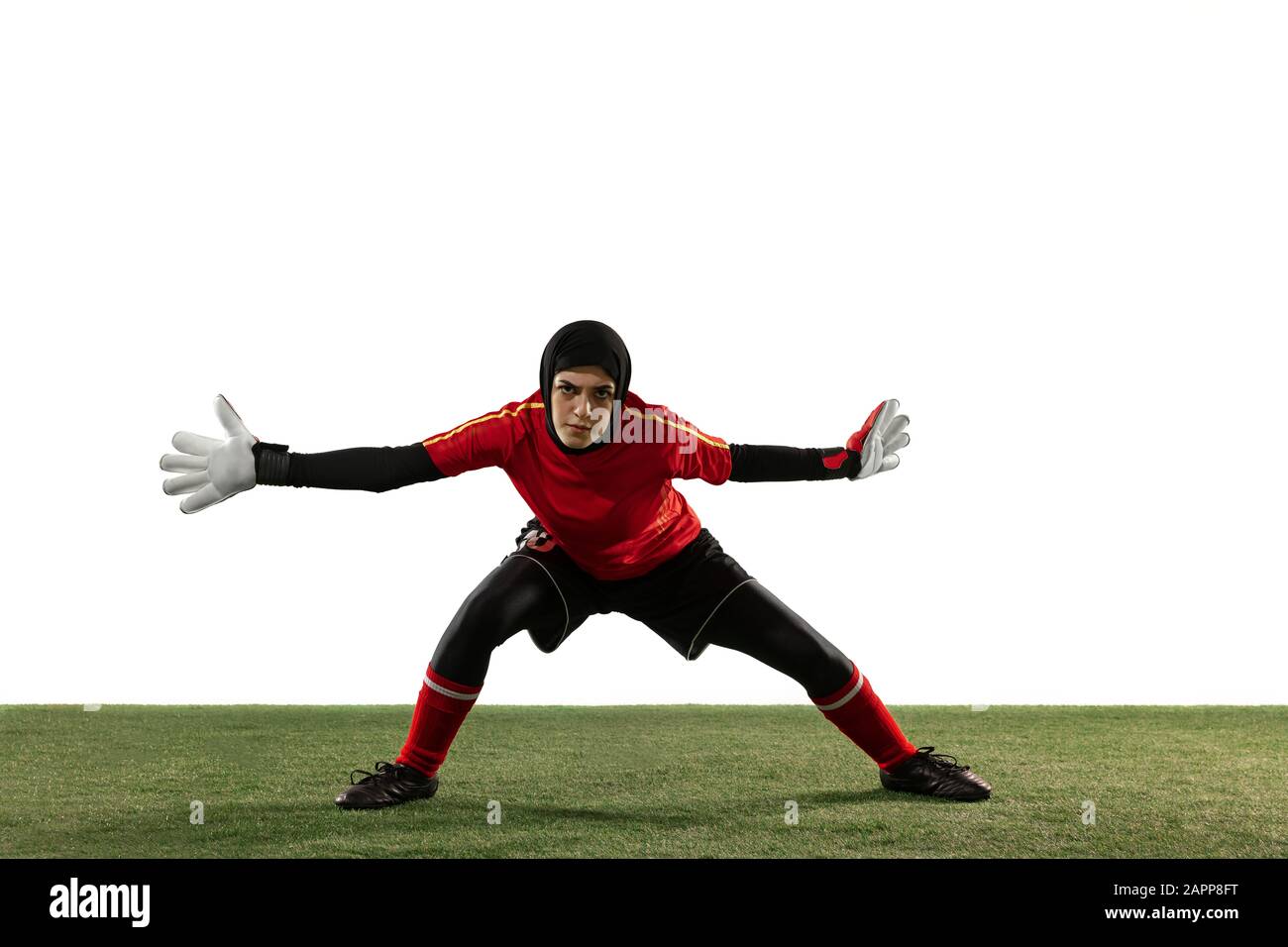 Arabian female soccer or football player, goalkeeper on white studio ...