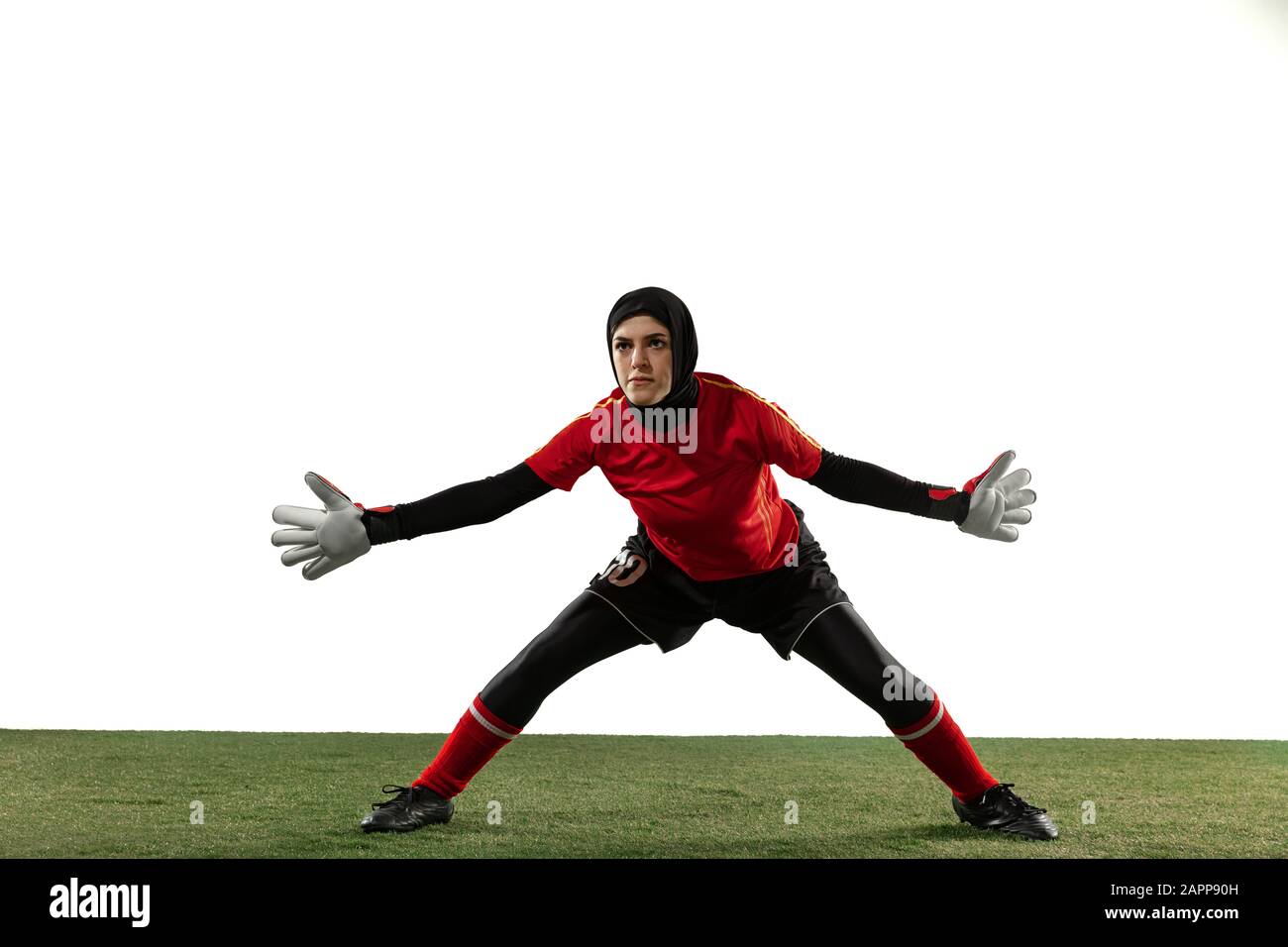 Arabian female soccer or football player, goalkeeper on white studio ...