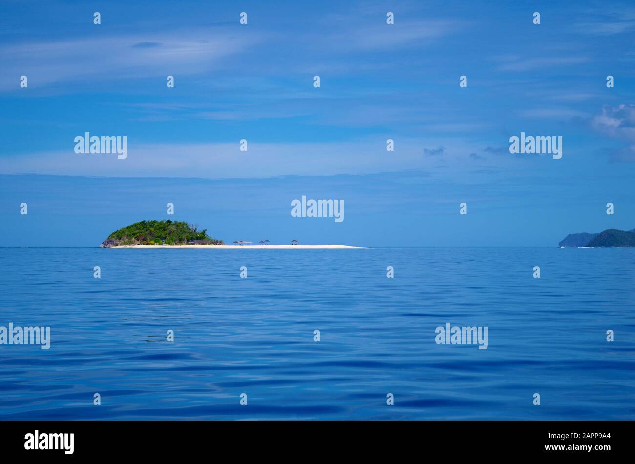 Very calm sea on a sunny day. There are few scattered clouds in the sky ...