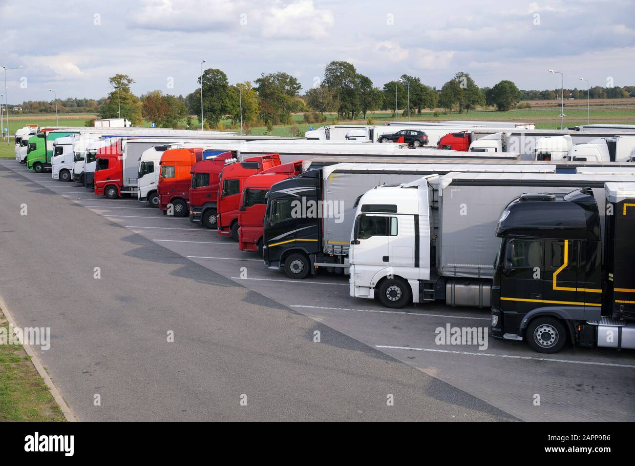Resting place. Various types of trucks in a crowded parking lot off the ...