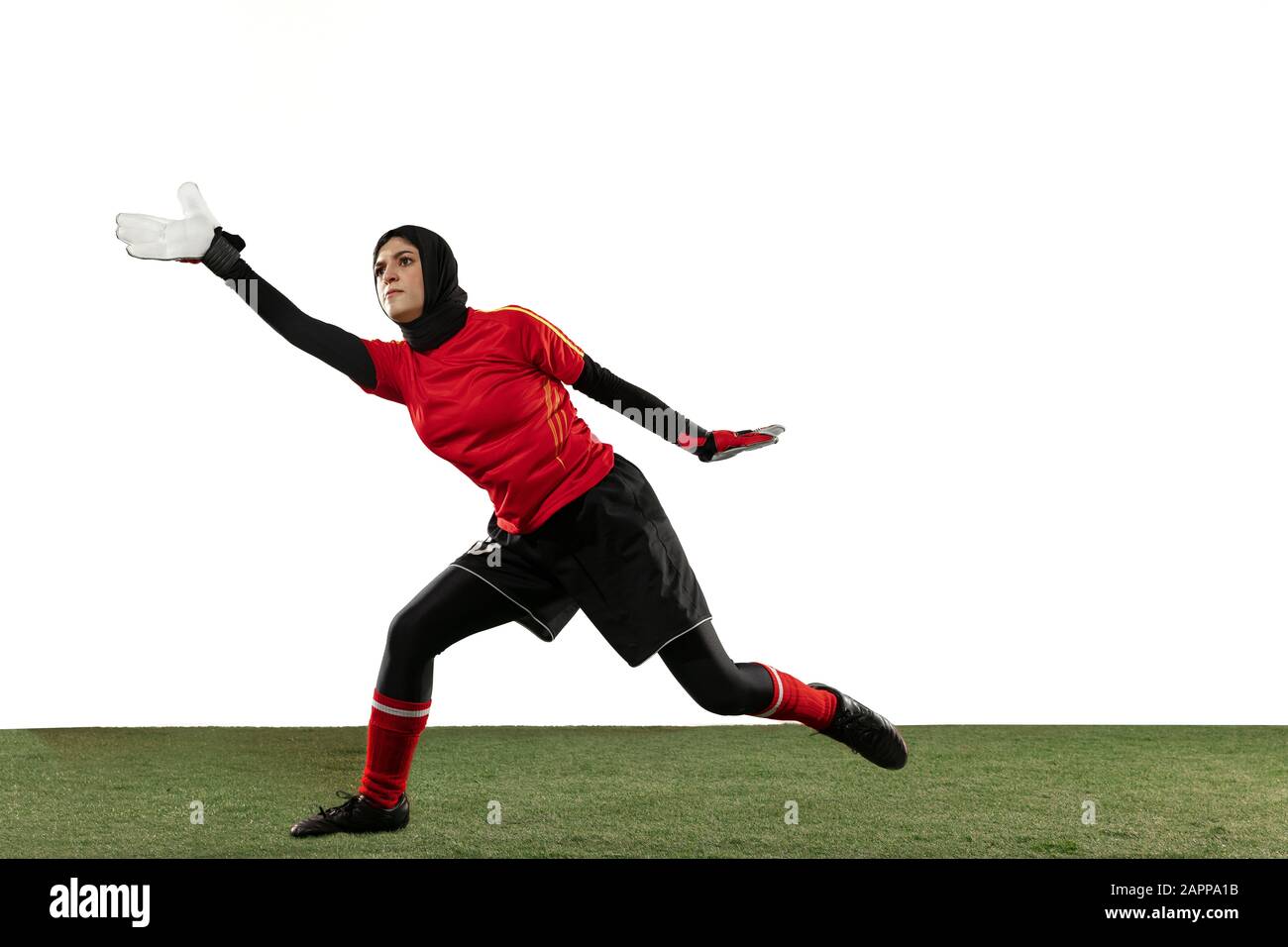 Arabian female soccer or football player, goalkeeper on white studio ...