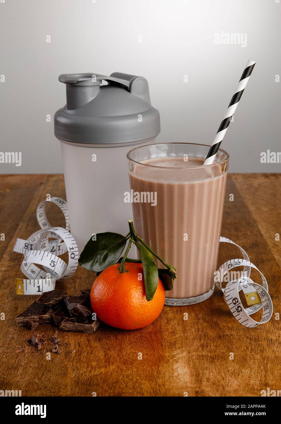 Chocolate orange milkshake, ingredients, tape measure and shaker with ...