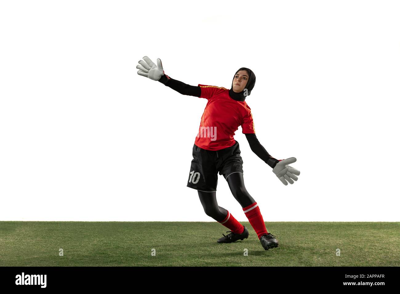 Arabian female soccer or football player, goalkeeper on white studio ...