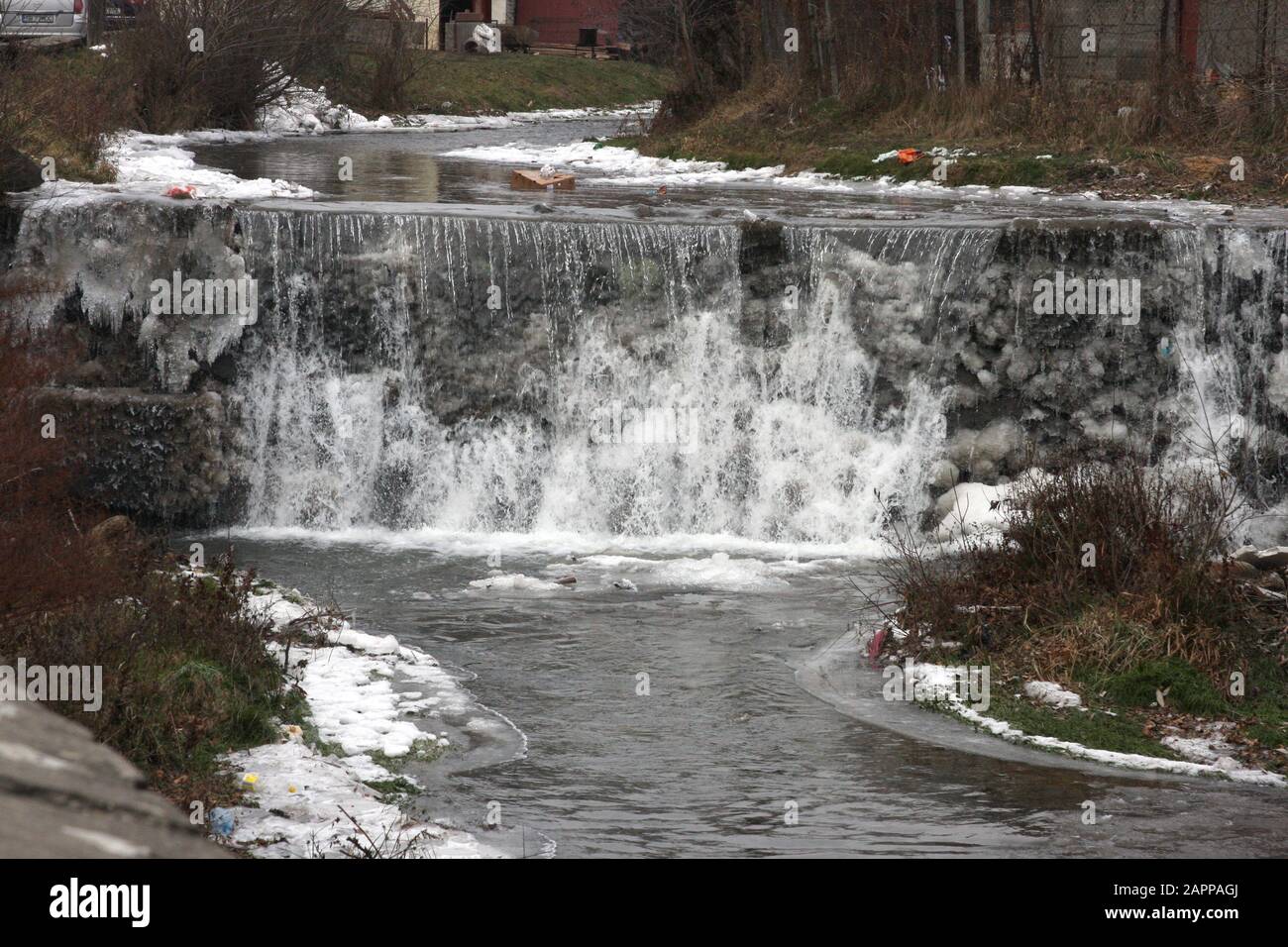 Half-frozen waterfall in Romania Stock Photo - Alamy