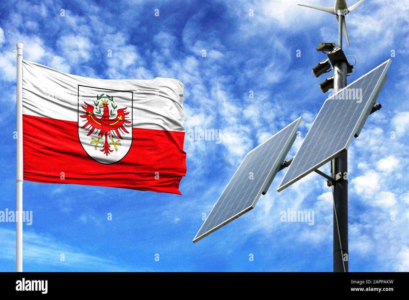 Solar panels on a background of blue sky with a flagpole and the flag ...