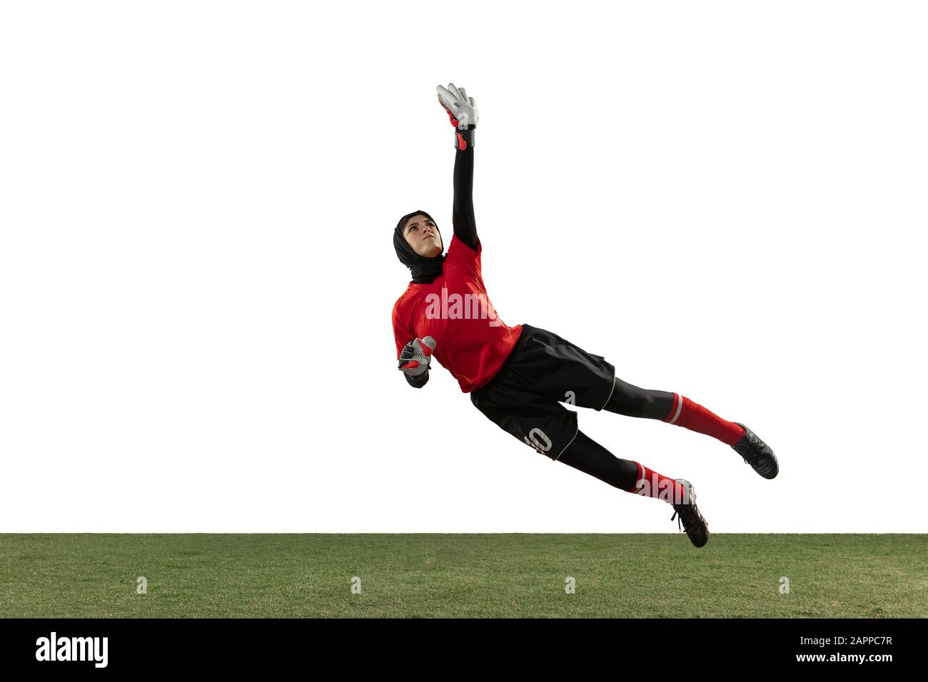 Arabian female soccer or football player, goalkeeper on white studio ...