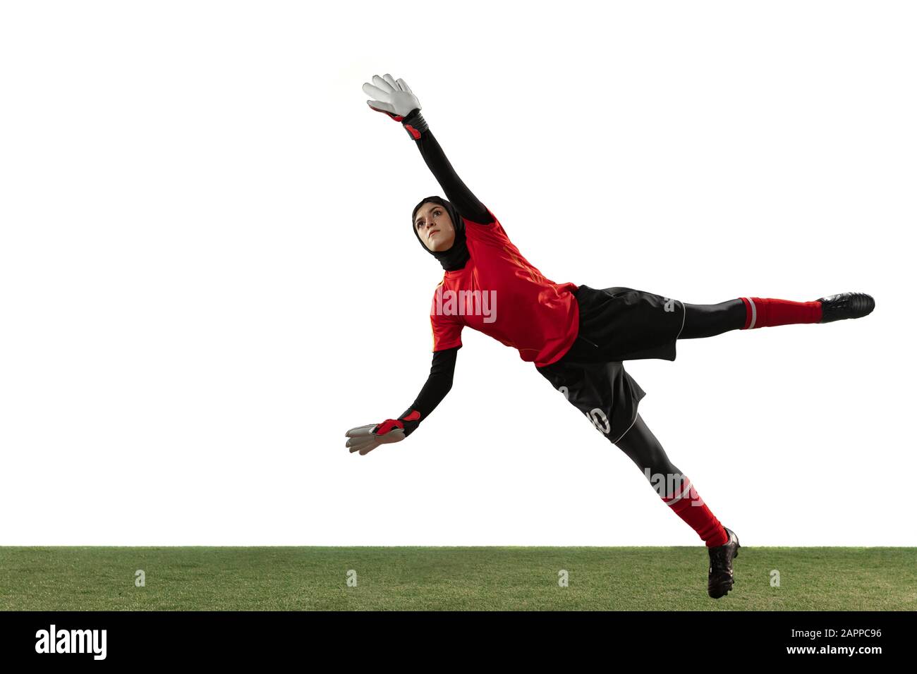 Arabian female soccer or football player, goalkeeper on white studio ...