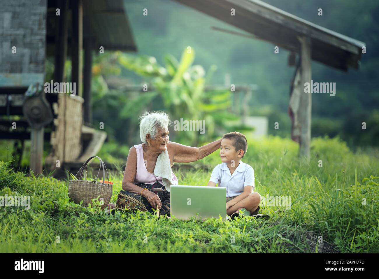 Happy boy and grandmother using a laptop outdoors Stock Photo - Alamy