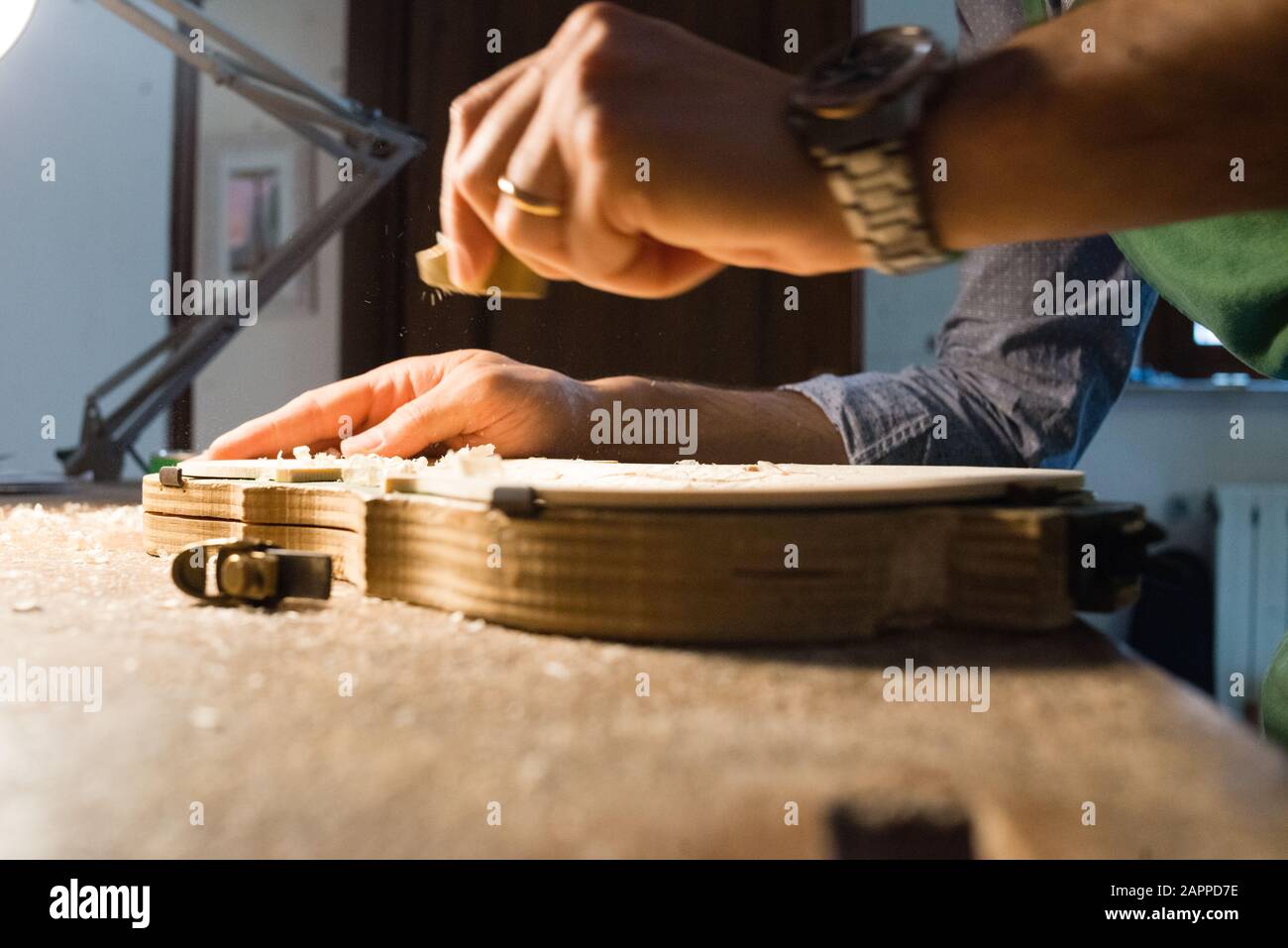 Violin maker at work in the laboratory with tools in Cremona Stock ...