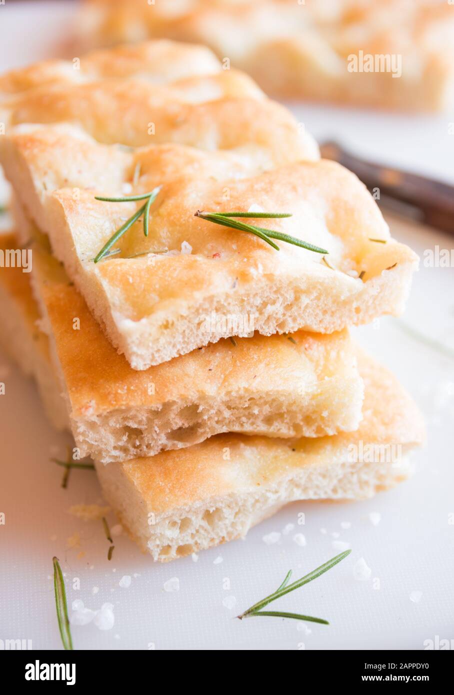 Simple plane pizza with rosemary and salt cut in pieces Stock Photo - Alamy