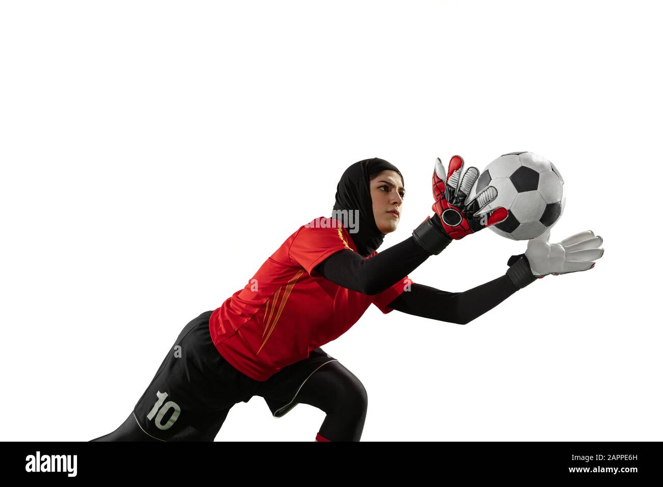 Arabian female soccer or football player, goalkeeper on white studio ...
