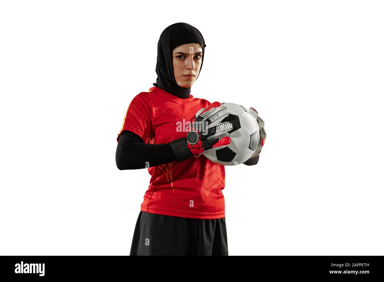 Arabian female soccer or football player, goalkeeper on white studio ...