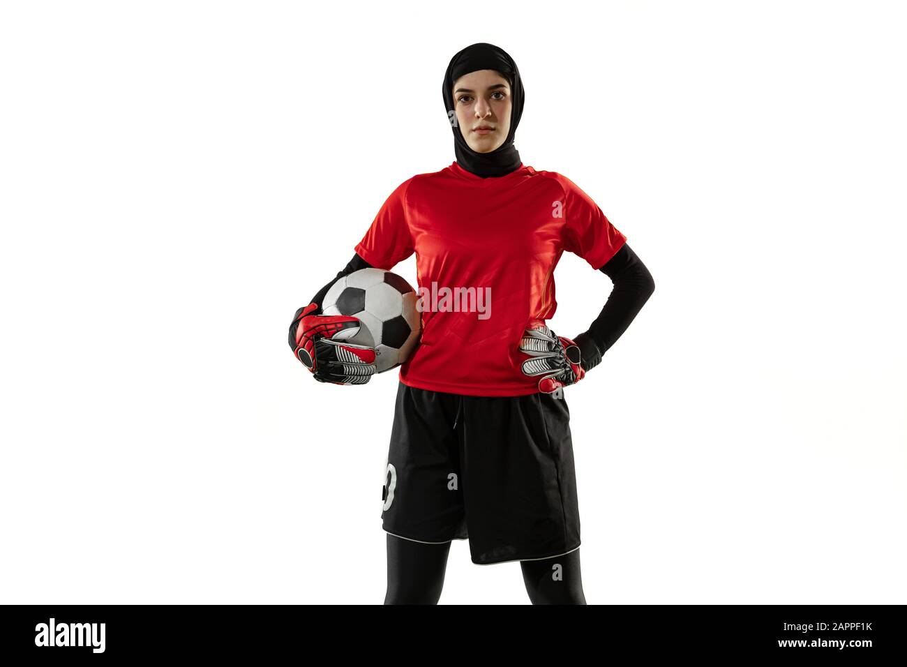Arabian female soccer or football player, goalkeeper on white studio ...