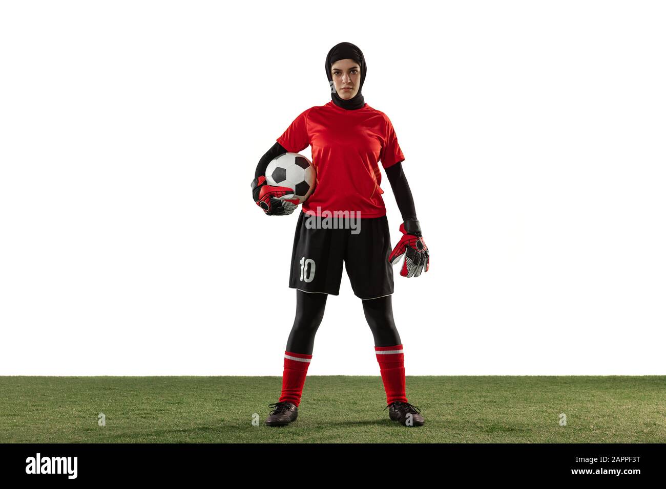 Arabian female soccer or football player, goalkeeper on white studio ...