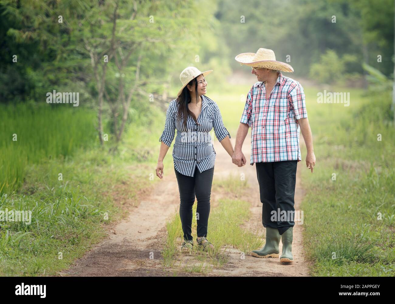 Happy senior couple taking a walk in summer countryside Stock Photo - Alamy