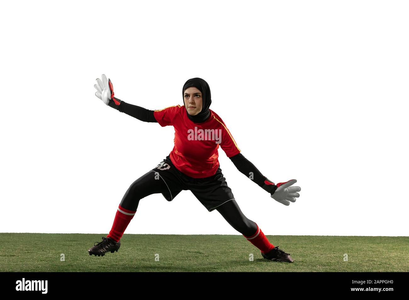 Arabian female soccer or football player, goalkeeper on white studio ...