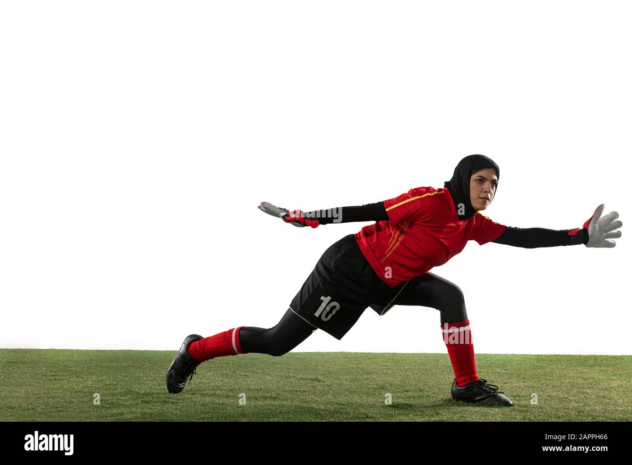 Arabian female soccer or football player, goalkeeper on white studio ...