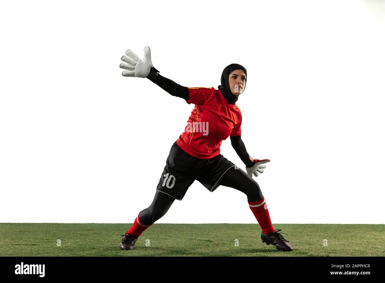 Arabian female soccer or football player, goalkeeper on white studio ...