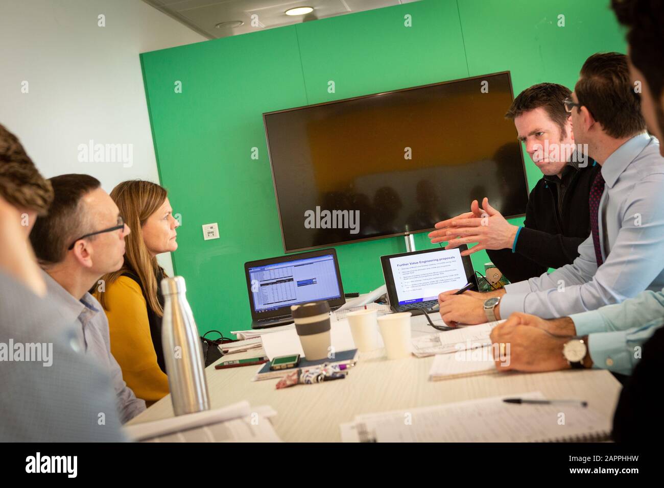 Man gesturing leading a discussion in an office meeting room Stock ...
