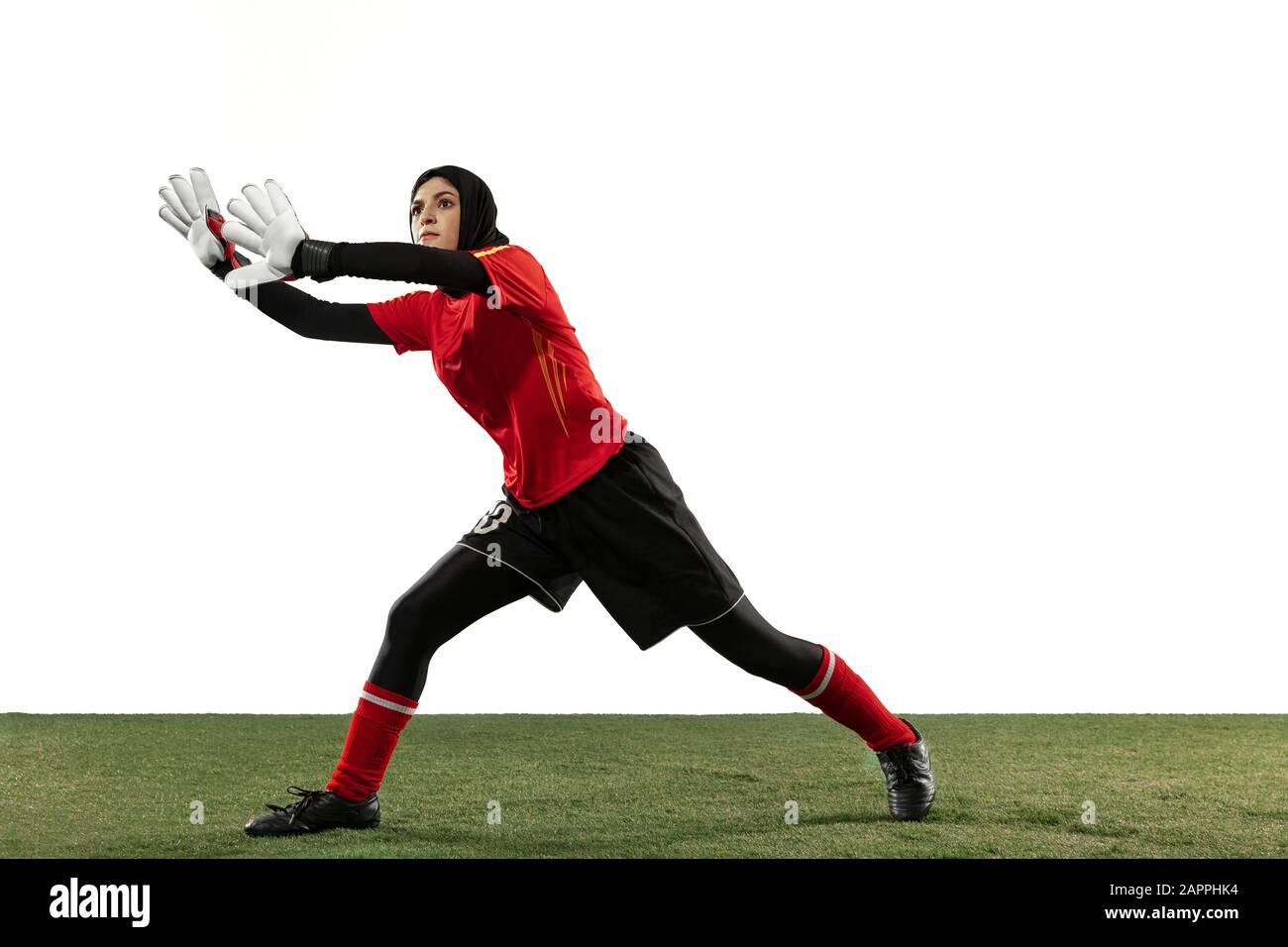 Arabian female soccer or football player, goalkeeper on white studio ...