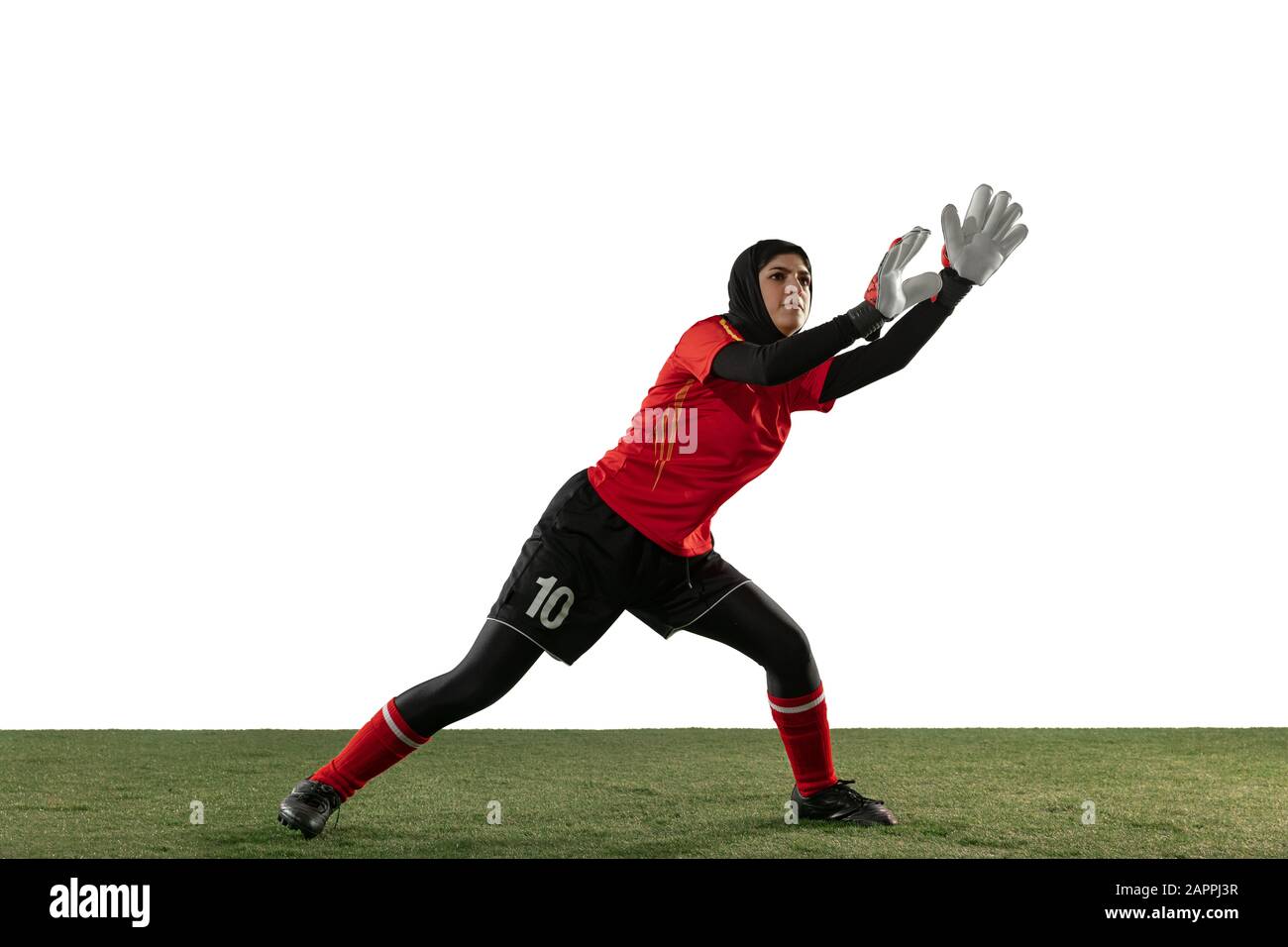 Arabian female soccer or football player, goalkeeper on white studio ...