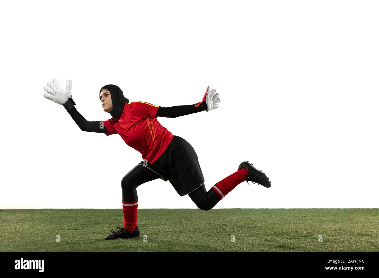Arabian female soccer or football player, goalkeeper on white studio ...