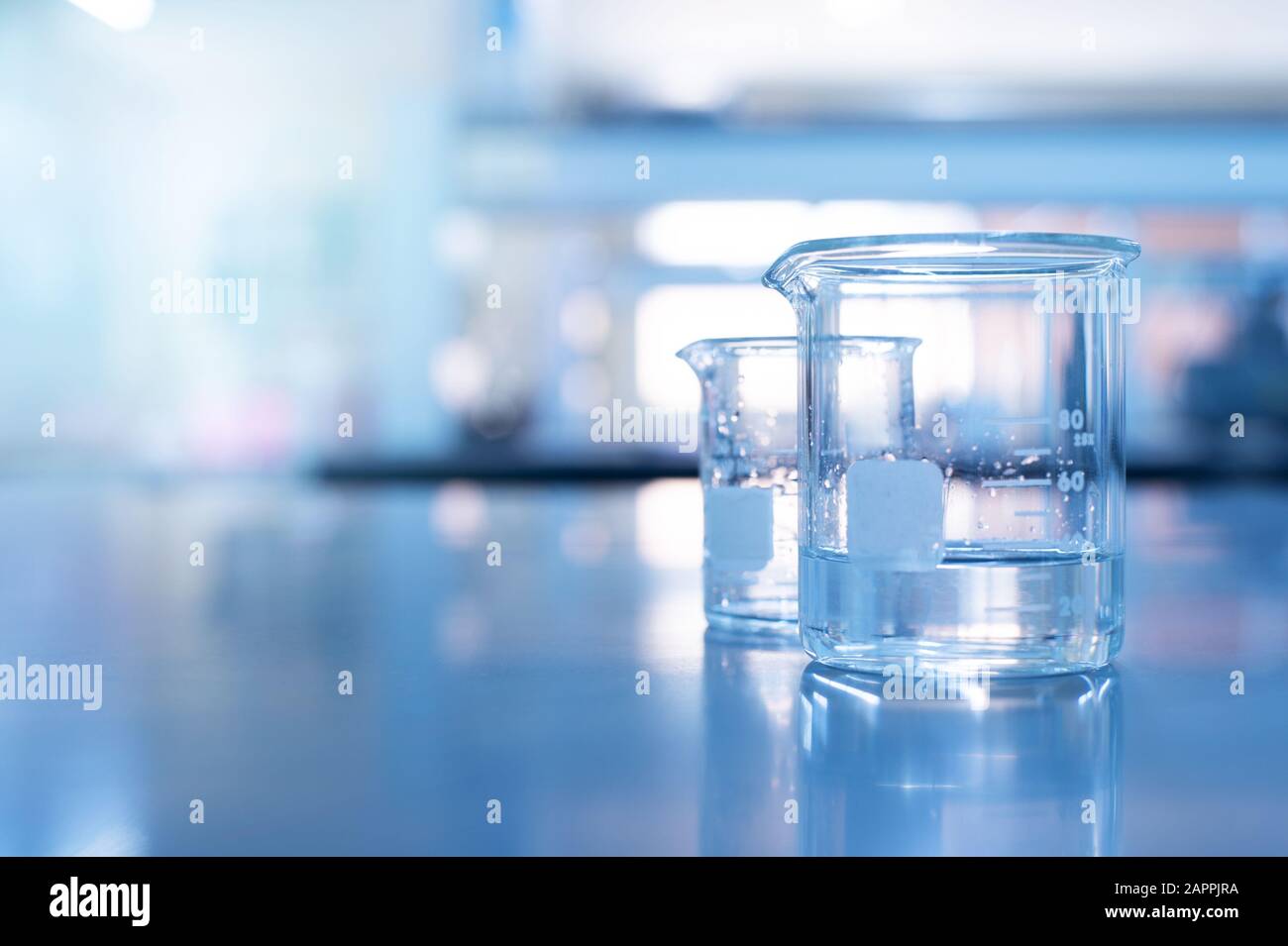 glass beaker with water in education chemistry blue science laboratory ...