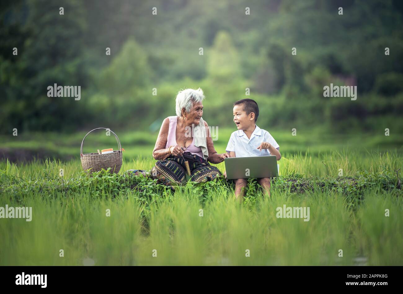 Happy boy and grandmother using a laptop outdoors Stock Photo - Alamy