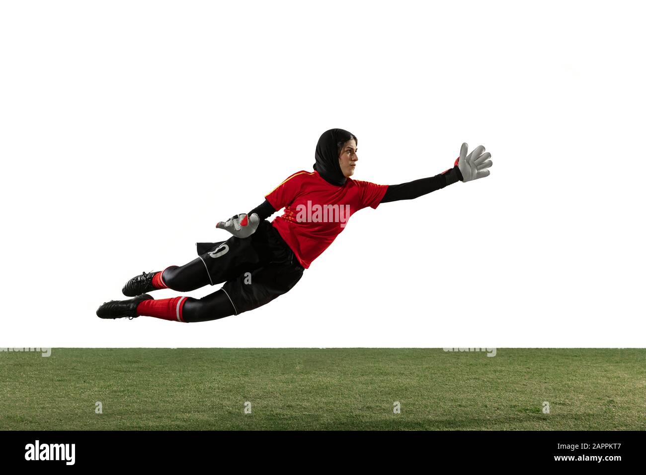 Arabian female soccer or football player, goalkeeper on white studio ...