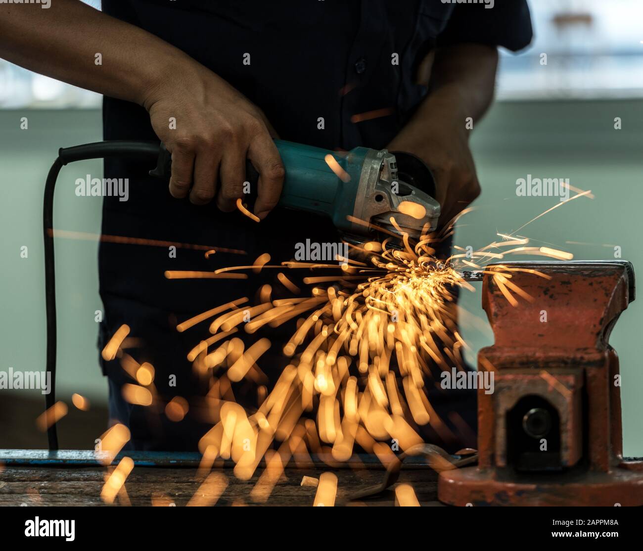 Electric wheel grinding on steel structure in factory Stock Photo - Alamy