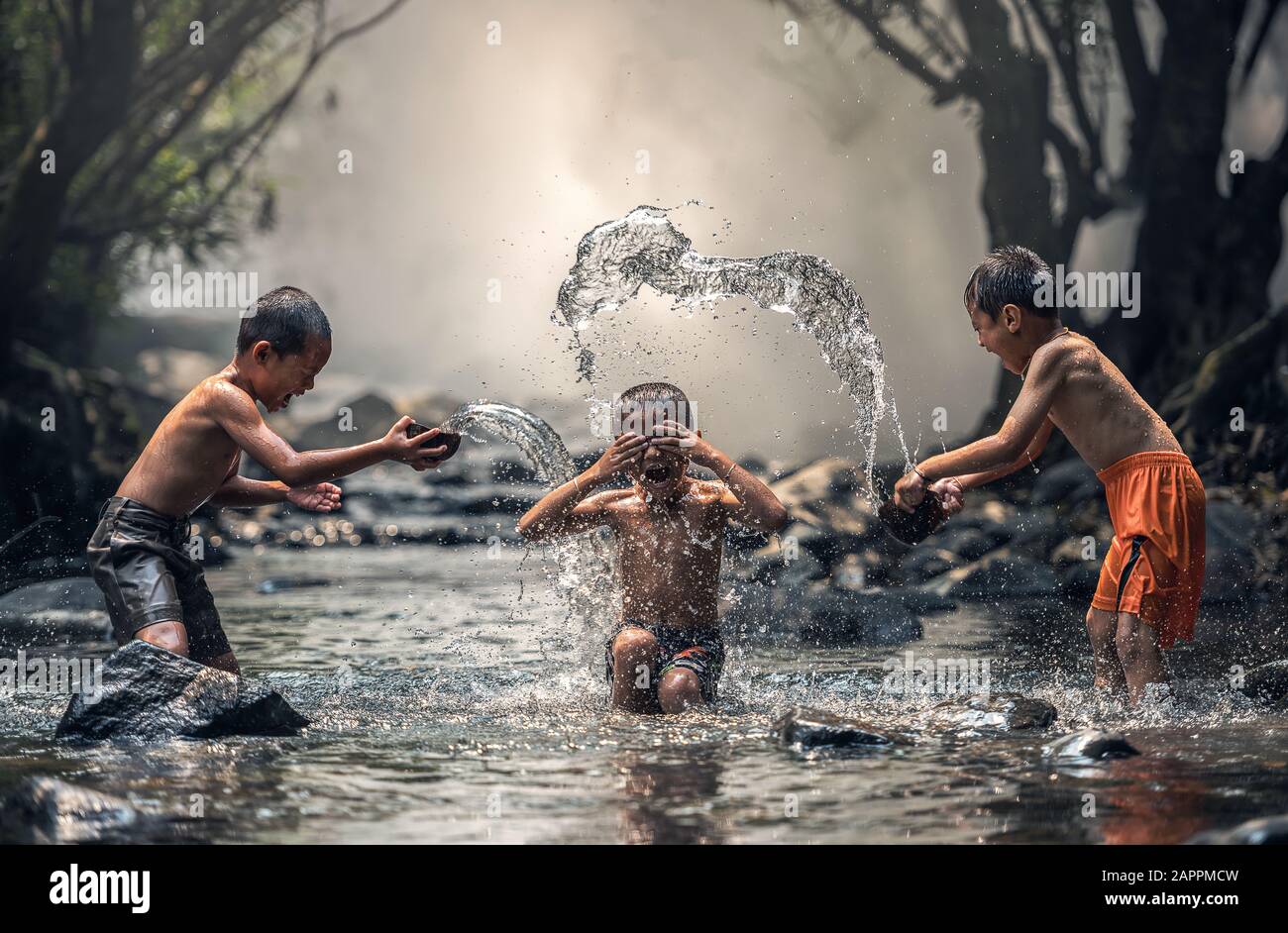 Three boy joyful with splashing Stock Photo - Alamy
