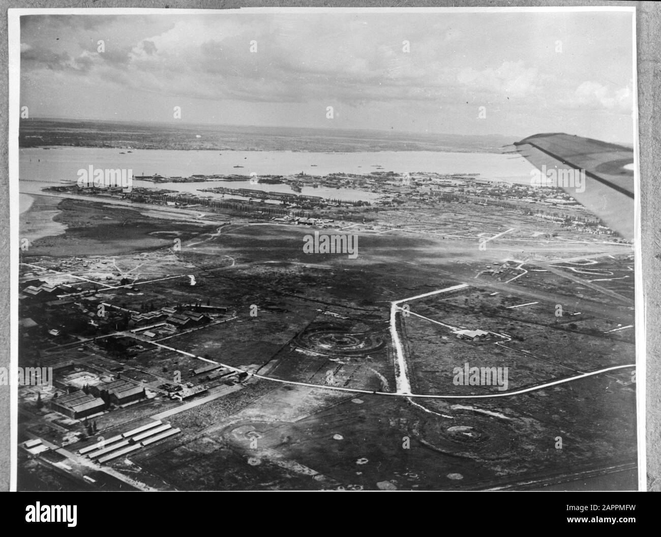 Aerial photograph of an airport by the sea and a port area Annotation ...