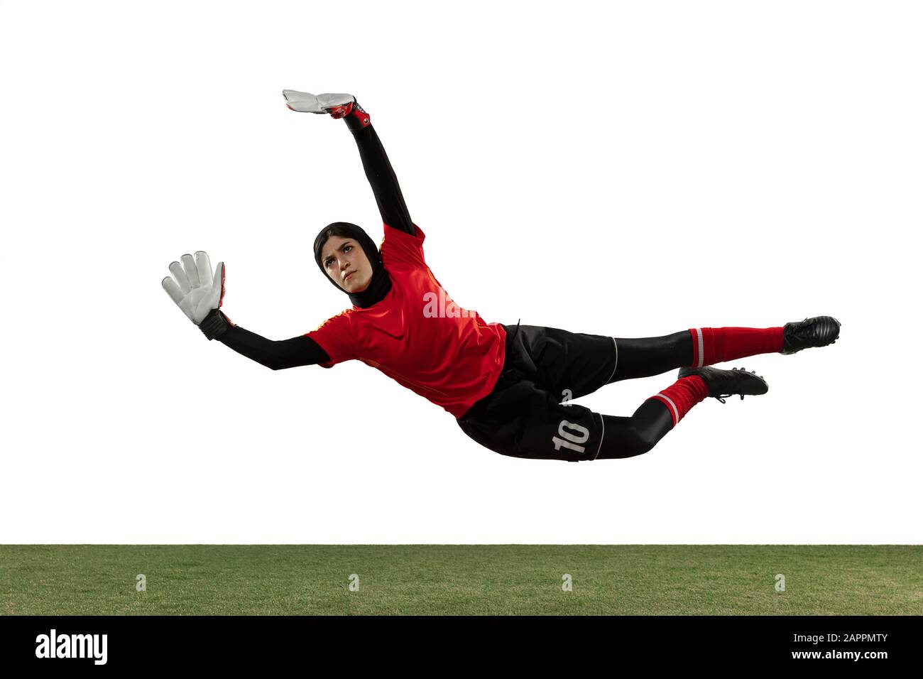 Arabian female soccer or football player, goalkeeper on white studio ...