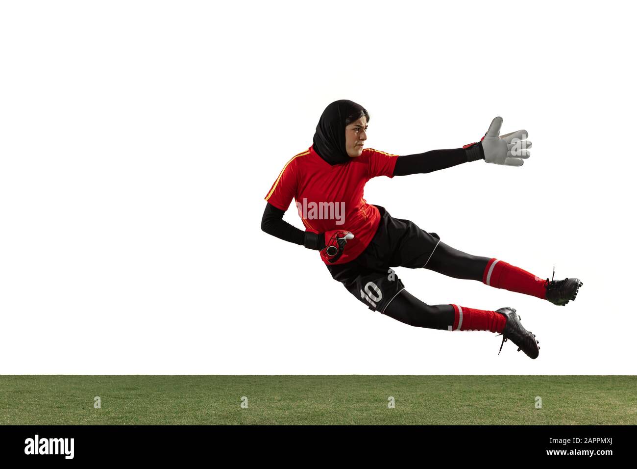 Arabian female soccer or football player, goalkeeper on white studio ...