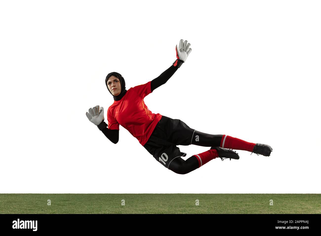 Arabian female soccer or football player, goalkeeper on white studio ...